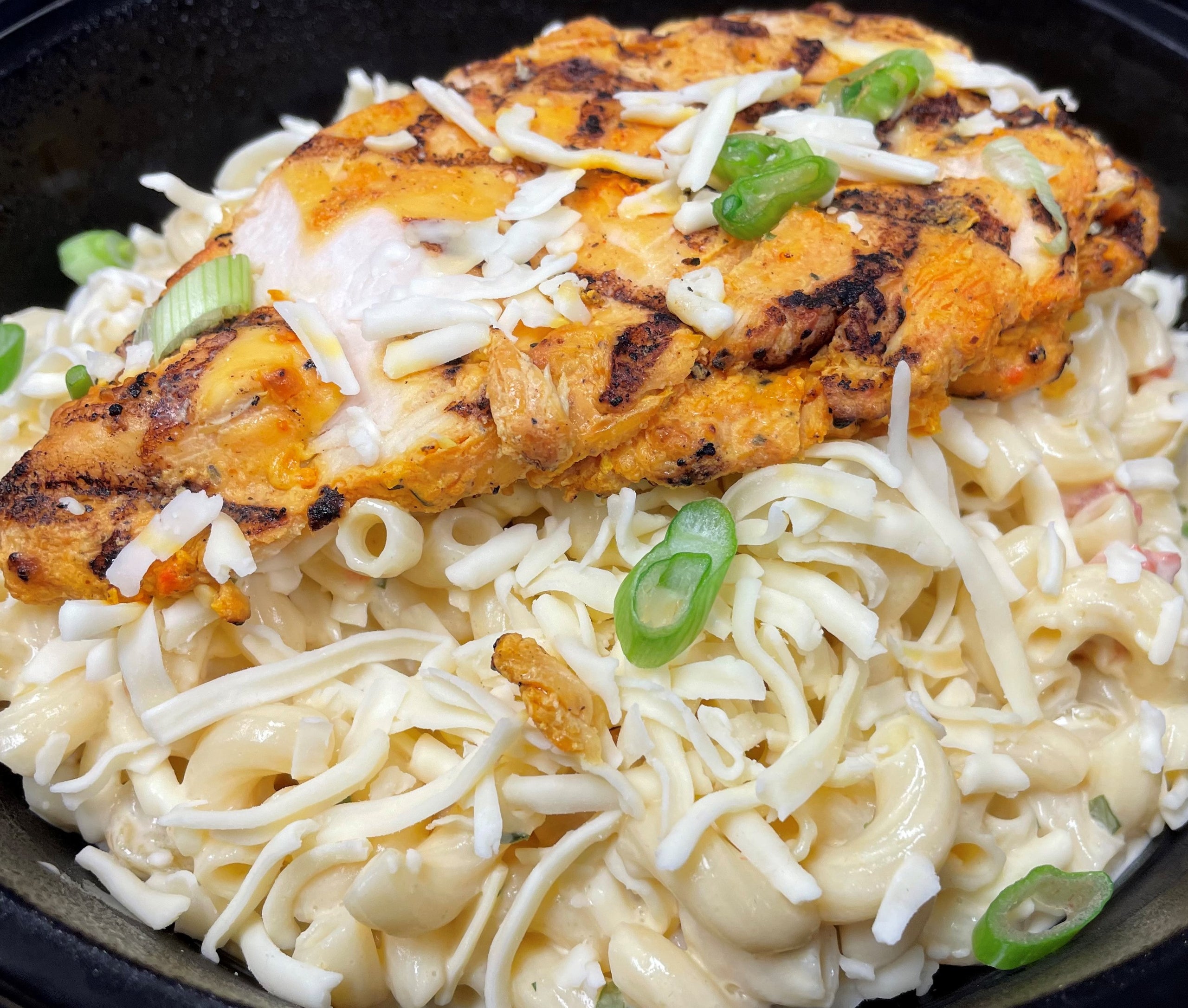 Chef Larry’s famous Queso served over macaroni with Grilled Chicken ...